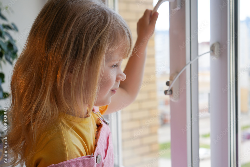safety at home for small children. a lock on the window protects ...