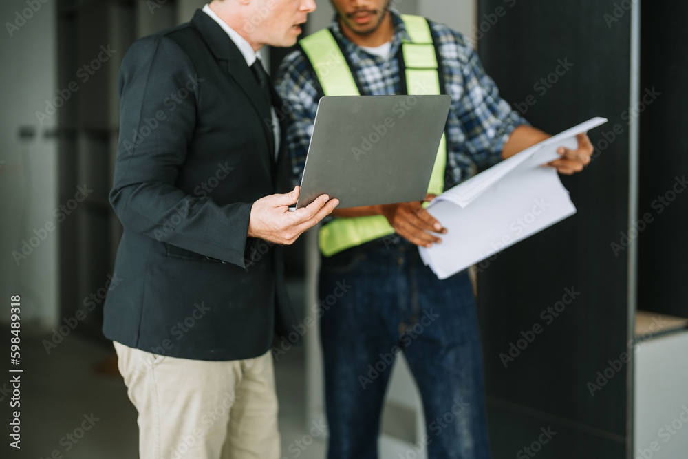 multi ethnic engineer brainstorming and measuring for cost estimating ...