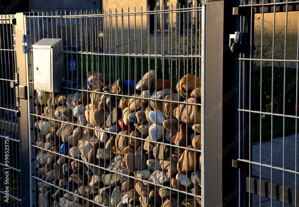 gabion fences filled with pebbles and quartz stones. some are colored ...
