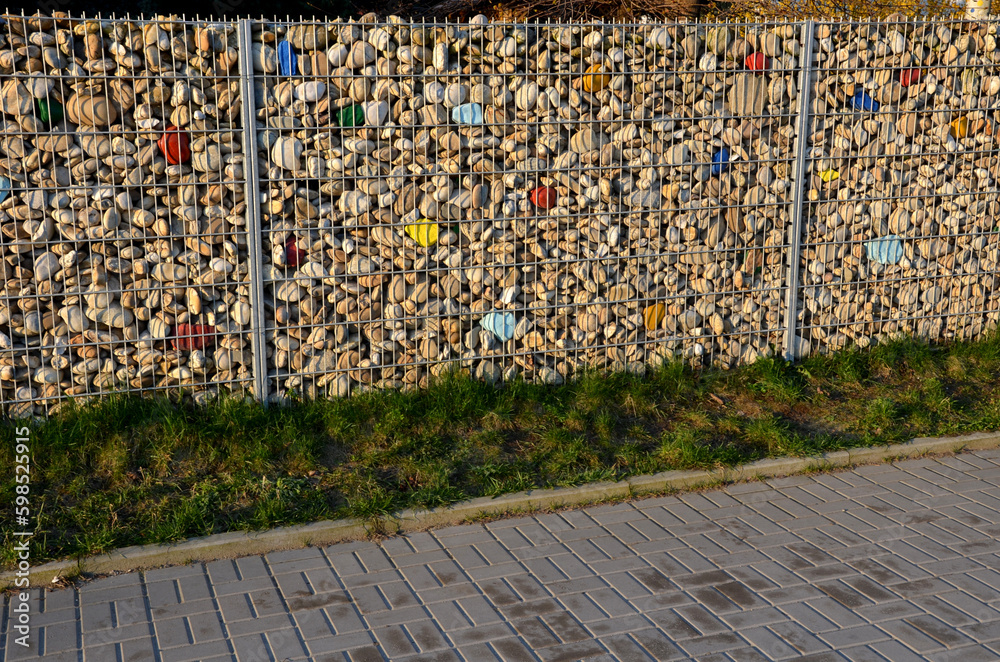 gabion fences filled with pebbles and quartz stones. some are colored ...