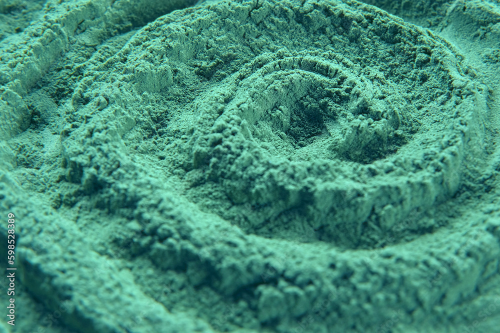 Chlorella or spirulina algae green powder is spinning, rotation ...