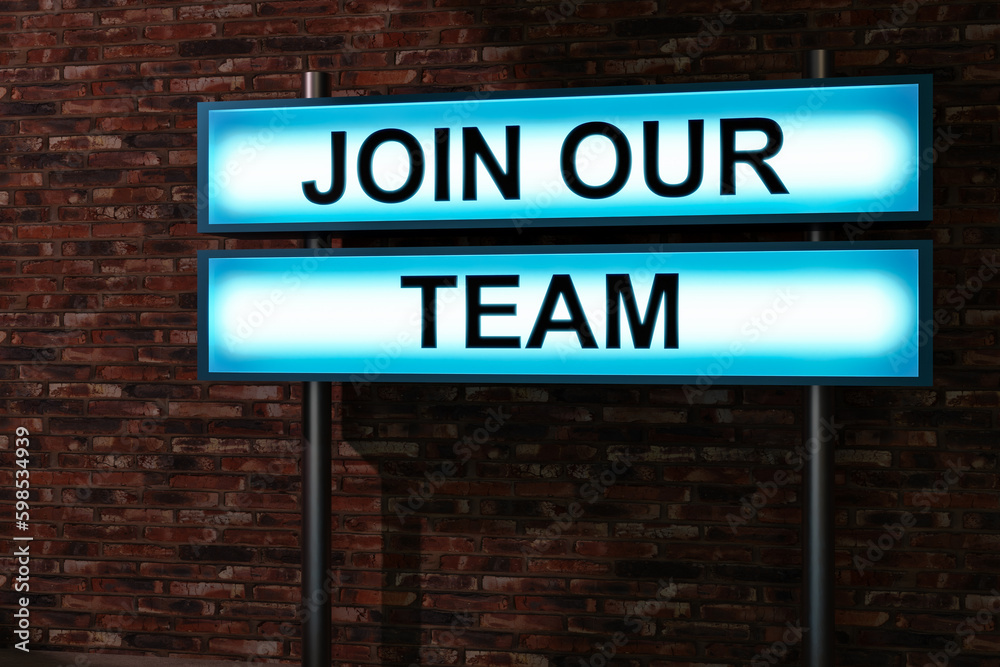 Join our team. Black letters on a light box. Illuminated sign in front ...
