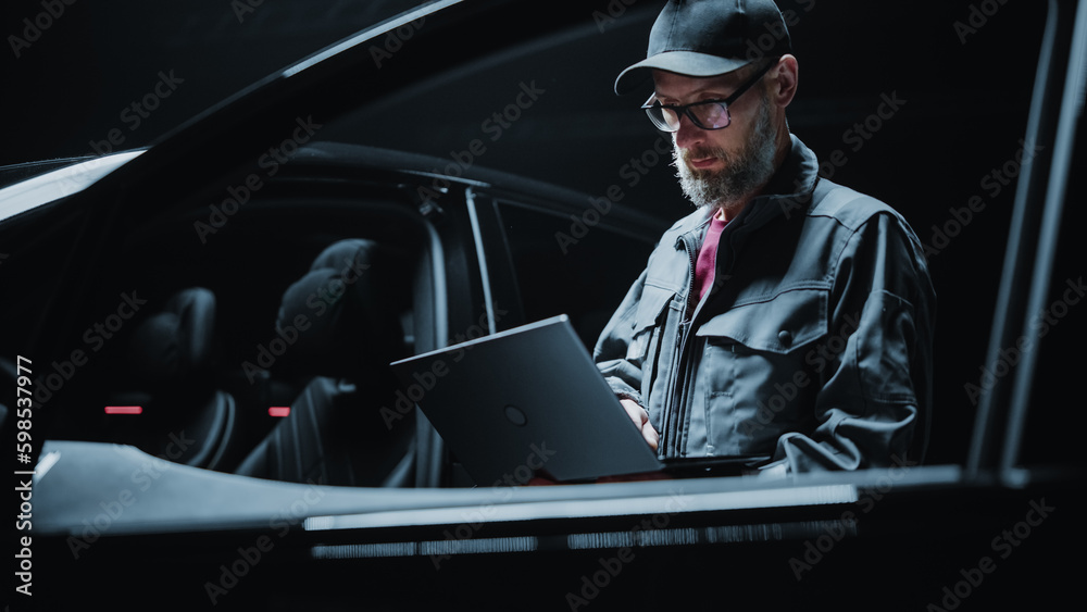 Portrait of a Dealership Car Mechanic Analyzing Diagnostics Results on ...