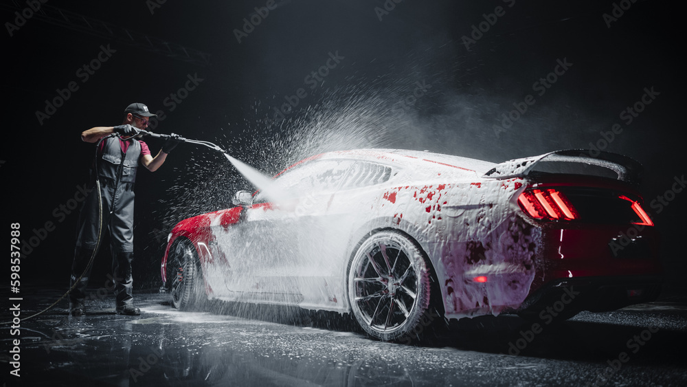Automotive Detailer Washing Away Smart Soap and Foam with a Water High ...