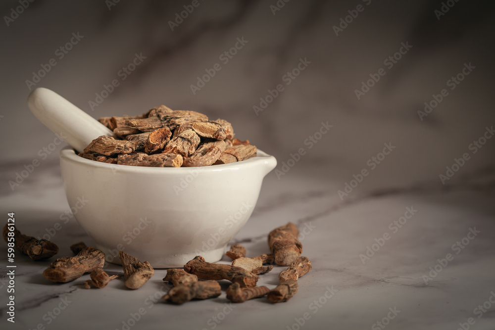 Closeup of Dry Sweet flag or Vach (Acorus calamus) roots, in a white ...