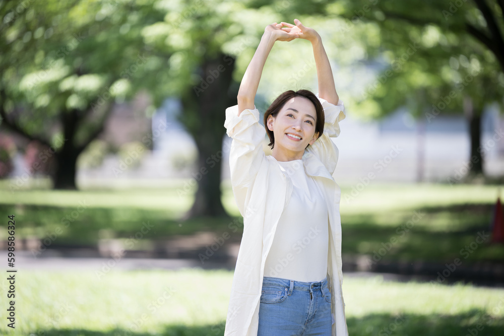 Beautiful woman taking a deep breath, relaxing and stretching in the ...