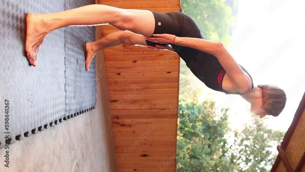 vertical shot. Young athletic woman trainer practicing hatha yoga ...