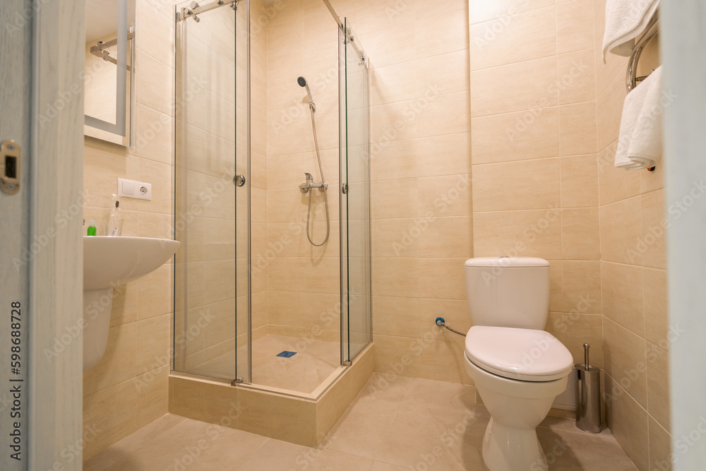 a bathroom in a modern inpatient clinic a toilet a shower cabin a sink ...