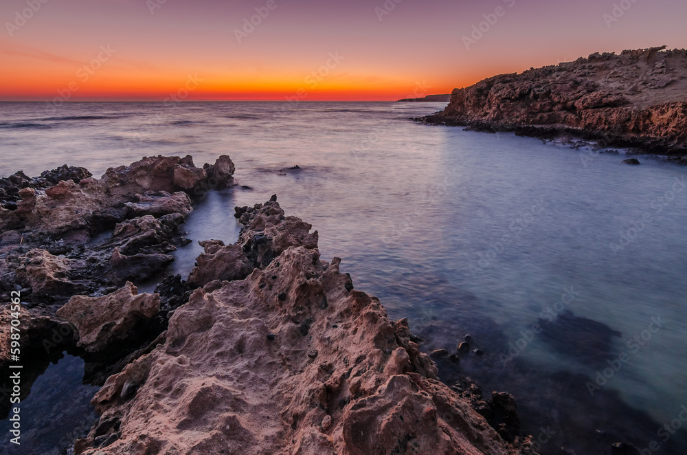 rocks beach sunset over the sea Stock Photo | Adobe Stock
