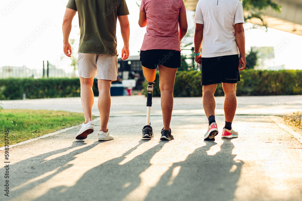 Friend support Friend with a prosthetic leg while exercising outdoor ...