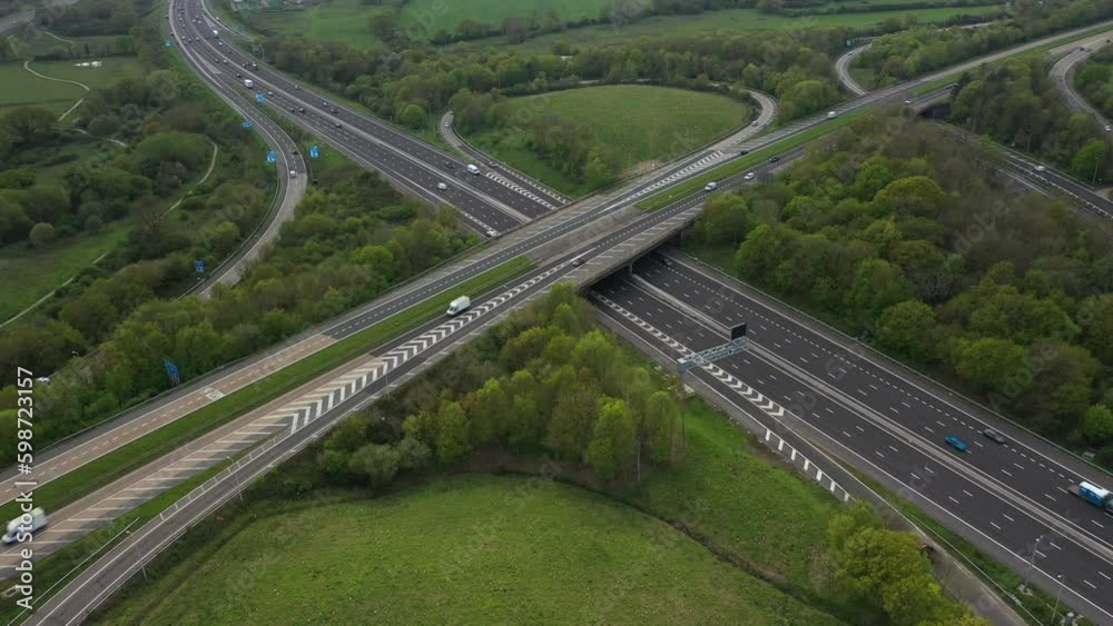 Flying over a busy motorway , lots of turns , lanes and intersections ...