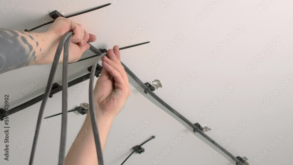 Installation of electrical wiring on apartment ceiling. Electrical ...