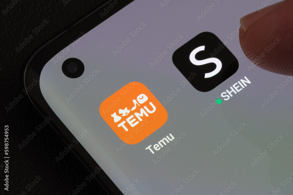 TEMU and SHEIN apps seen on the screen of smartphone. Temu app and Shein app are chinese budget ...