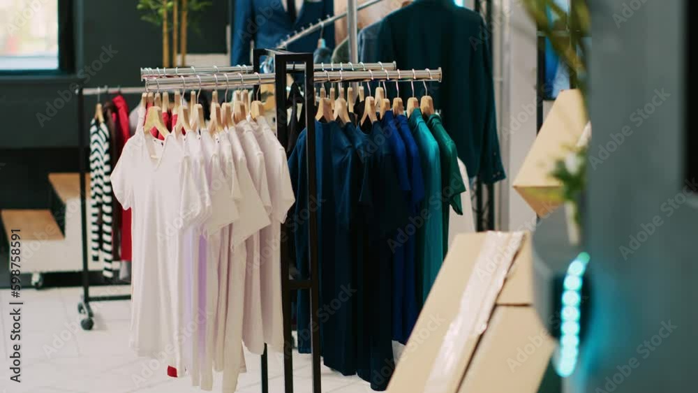 Empty modern boutique with casual and formal wear items, retail shop ...