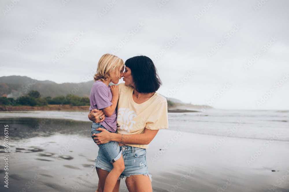 mom touching noses eskimo kiss with her son at the beach Stock Photo ...