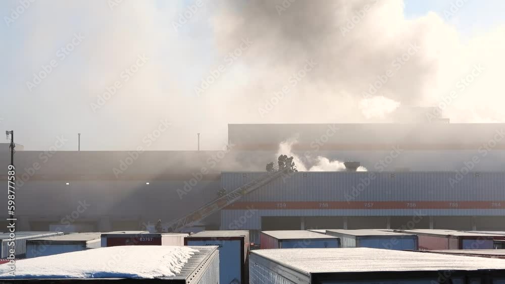 Burnt industrial warehouse or logistics center building with huge smoke ...