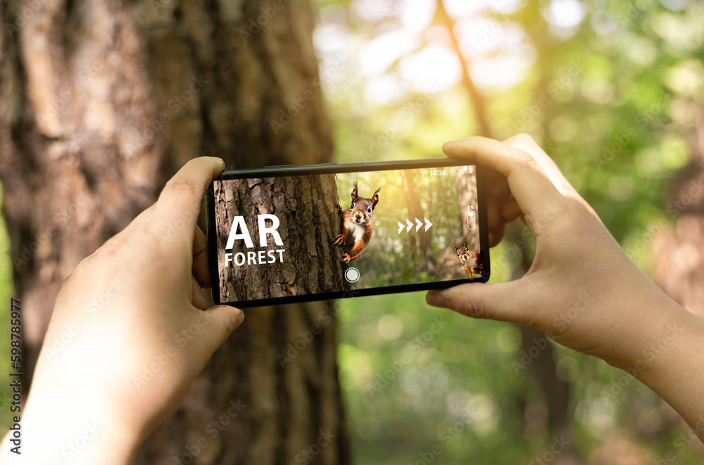 Hand of a woman experiencing an augmented reality (AR) application ...