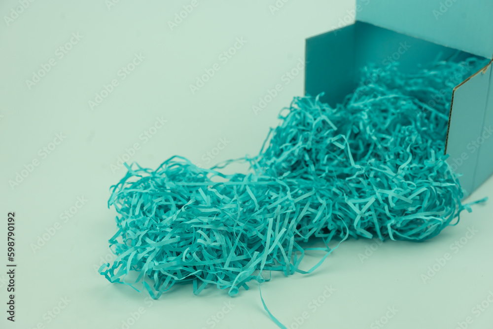 Blue box with blue shredded paper packing material for your product ...