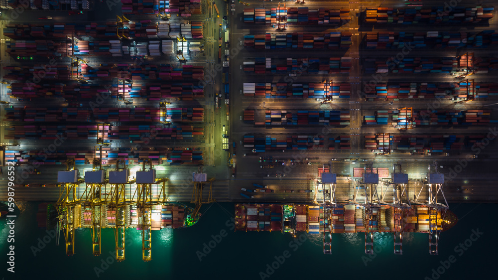 night scene commercial port loading and unloading cargo from container ...