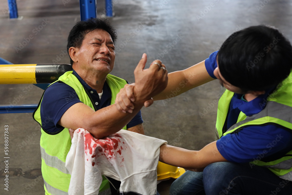 Middle aged warehouse asian worker man had elbow accident sitting on ...