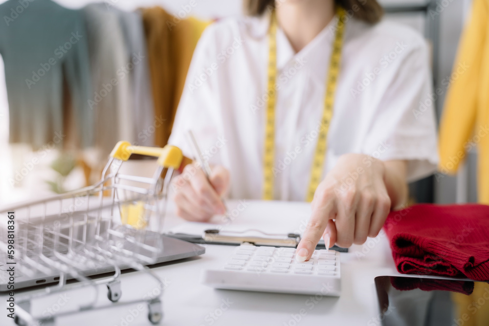 Entrepreneur using calculator with pencil in her hand, calculating ...