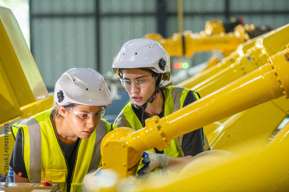 Two engineer in uniform helmet inspection check control heavy machine ...