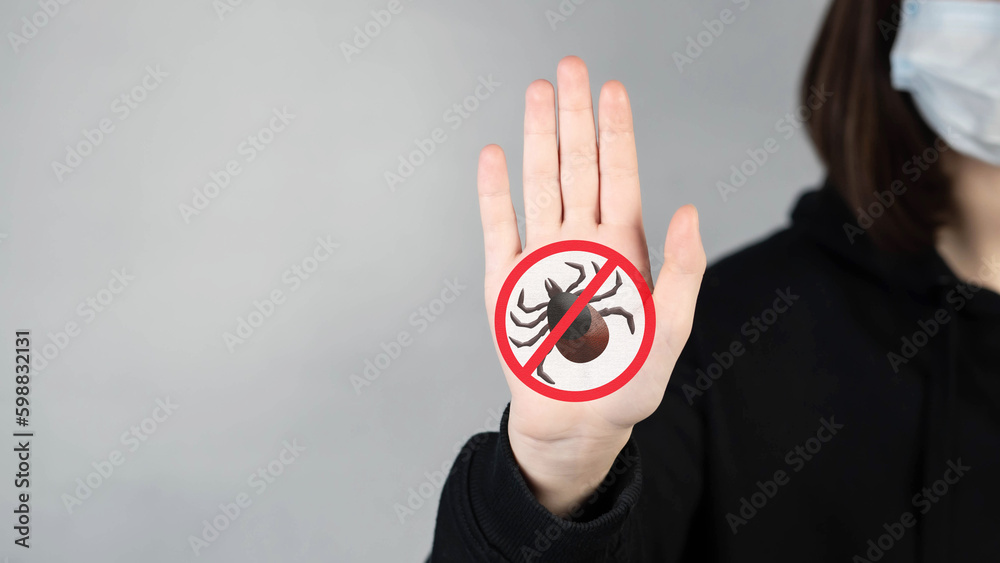 Tick parasite icon. On the hand is a warning crossed out sign about ...