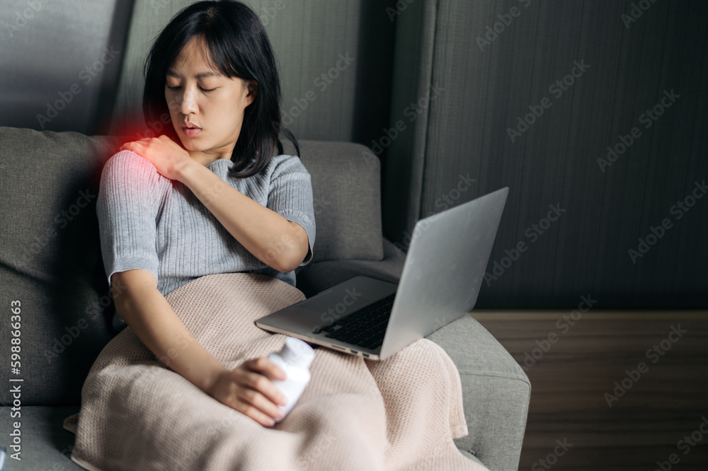 Asian woman has shoulder pain. Female holding painful shoulder with ...