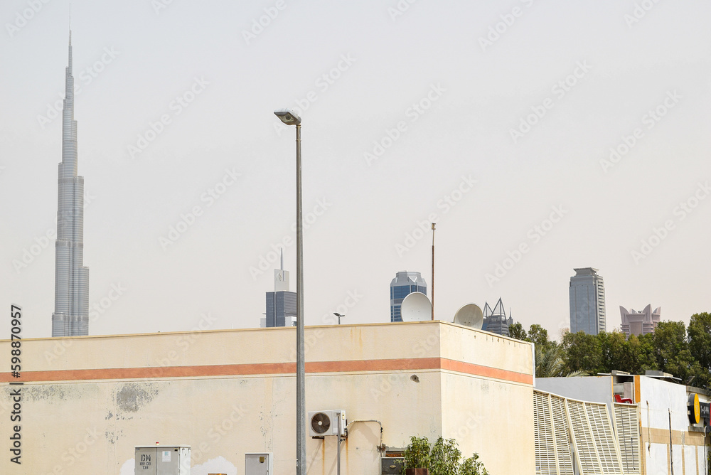 Daytime view of the iconic skyscraper Burj Khalifa over buildings ...