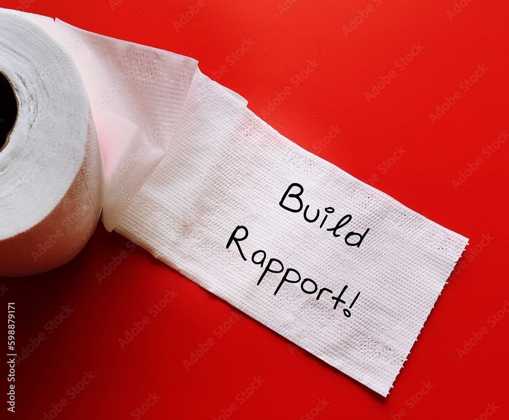 Toilet paper on red background with handwriting BUILD RAPPORT, to ...