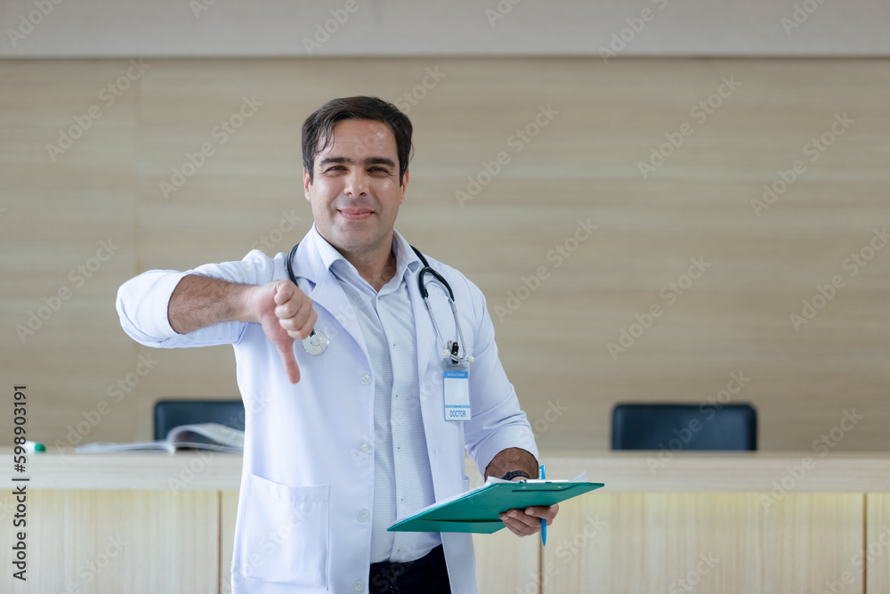 Foto de Male doctor white coat show hand thumb down not approved ...