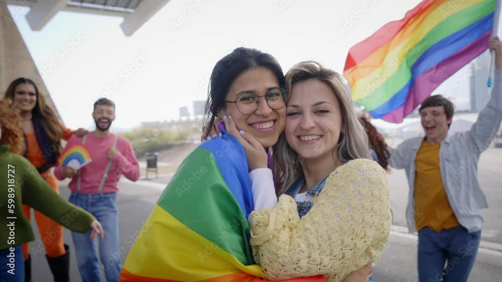 Lesbian couple with a Group of excited young friends enjoying together ...