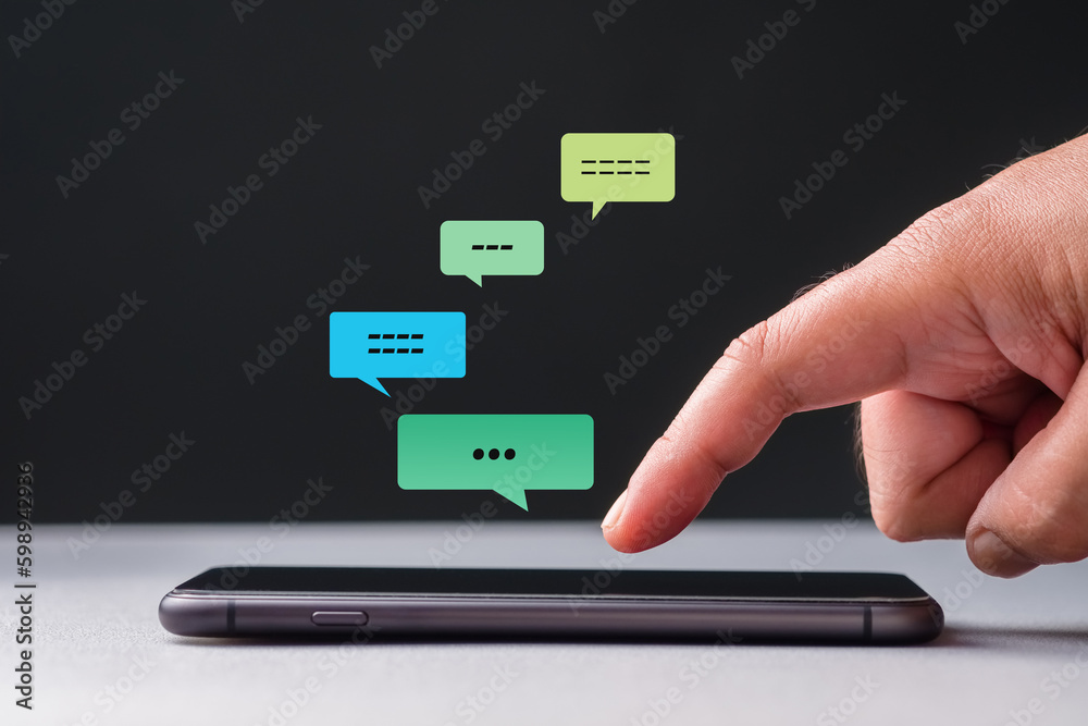 Closeup index finger is going to touch the screen of a smart phone to ...