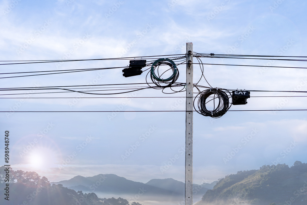 Black boxes and cable reels on poles. Internet box or splitter box with ...