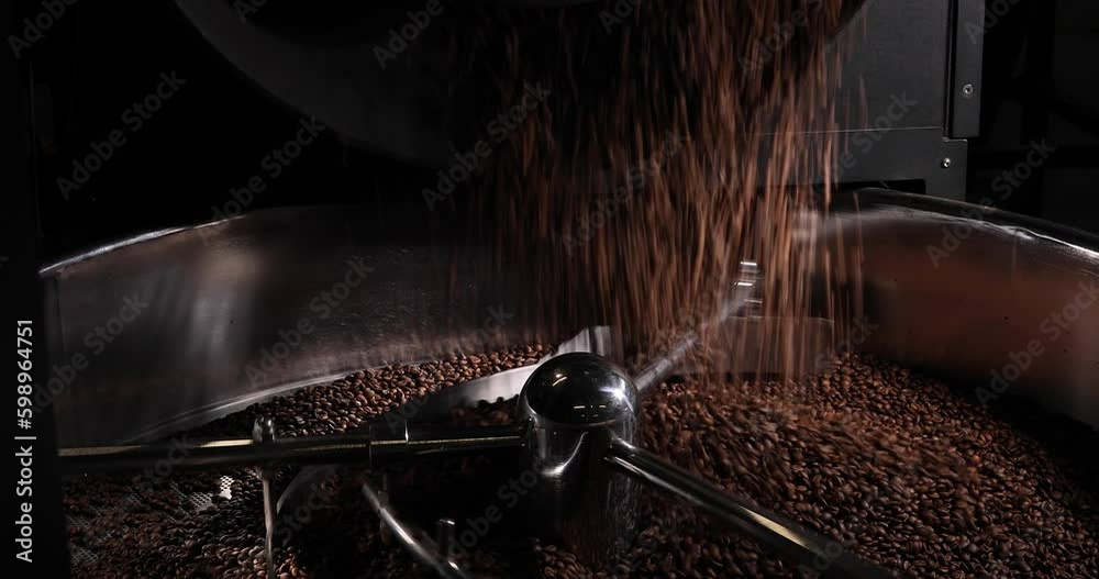 Close-up of the rotating mechanism of a modern coffee roaster stirring ...