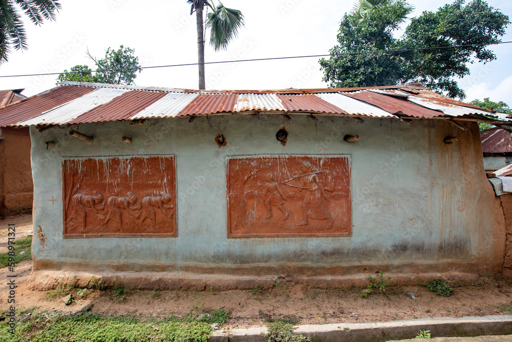 Tribal mural on wall of a mud house in a tribal village in Birbhum ...