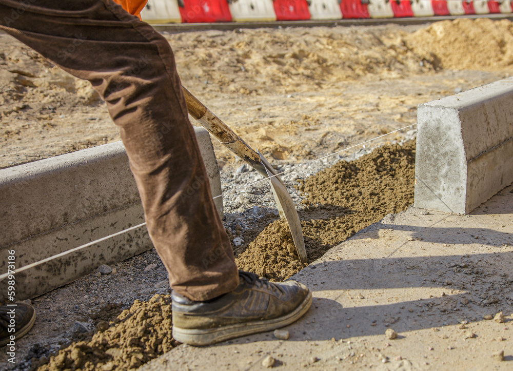 The process of building and repairing a sidewalk paved with brick, a ...