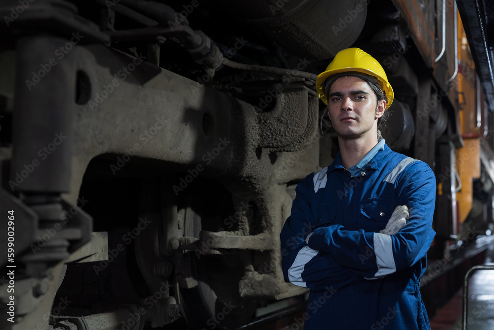 Portrait of male engineer worker standing with crossed arms, wearing ...