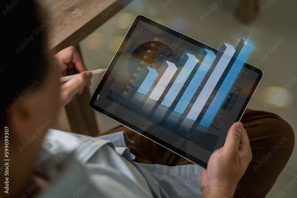 A businessman draws a growth graph showing the success of business ...