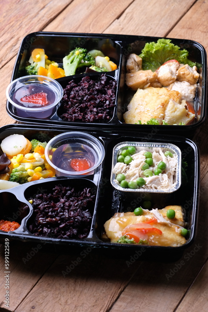 healthy food bento with black rice, dori fish fillet, vegetable soup ...