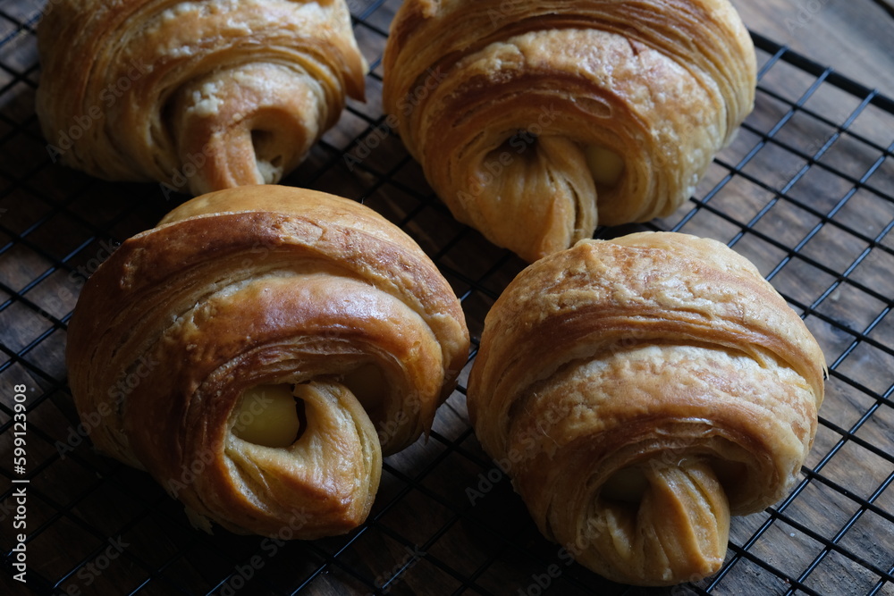 croissants on a cooling rack. croissant, which originated in France, is ...