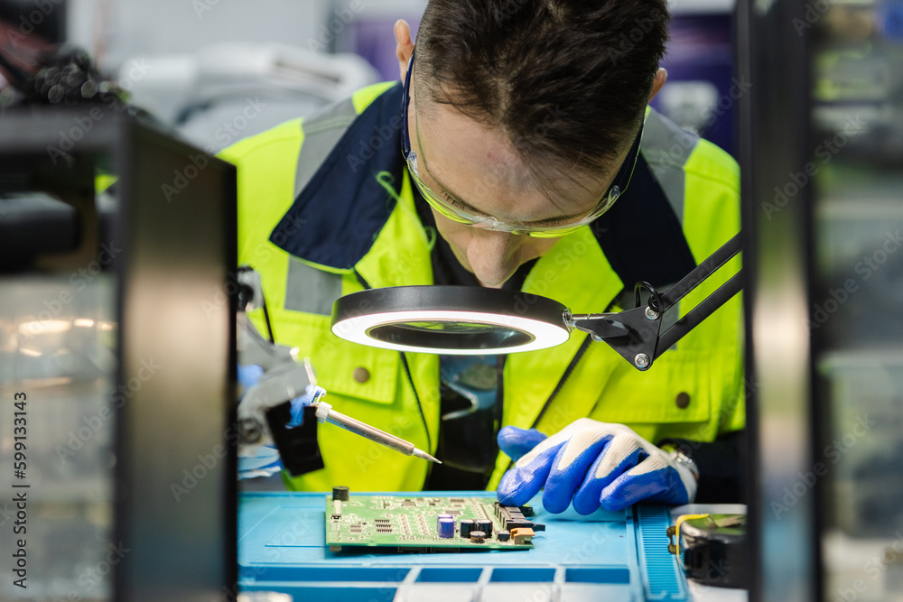 man electrical engineer using solder repairing instrument microchip ...