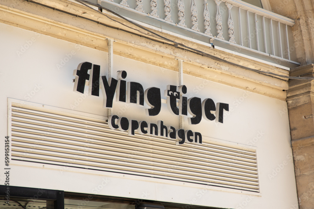 Flying Tiger Copenhagen logo brand and text sign front facade entrance ...