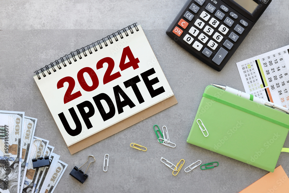 2024 UPDATE gray background with notepad and calculator Stock Photo ...