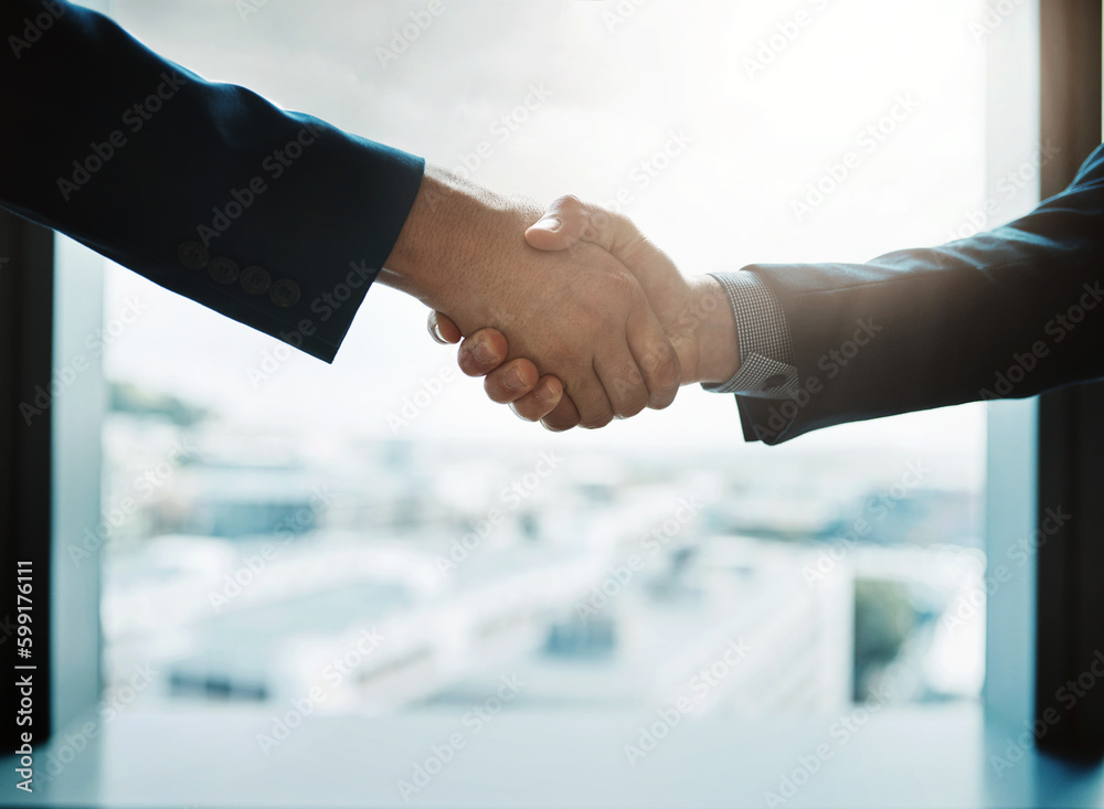 Building a strong business network. two businessmen shaking hands in a ...