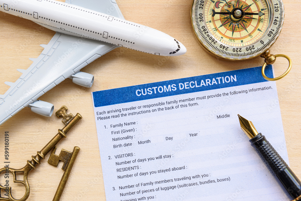 Customs declaration form with a compass, a white model airplane, two ...