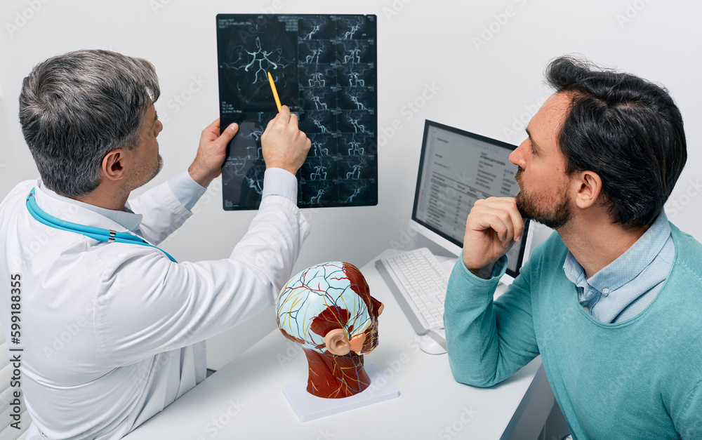 Man with migraine and headache at consultation with neurologist who ...