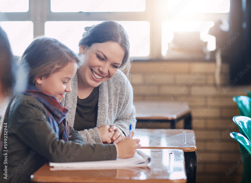 Youre almost there, keep going. an elementary school girl getting help ...