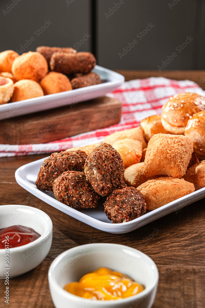 Various brazilian snacks deep fried. (Coxinha, kibe, empadinha e ...