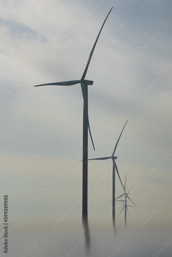 Windmills with rotor blades producing renewable green energy. Windmills ...